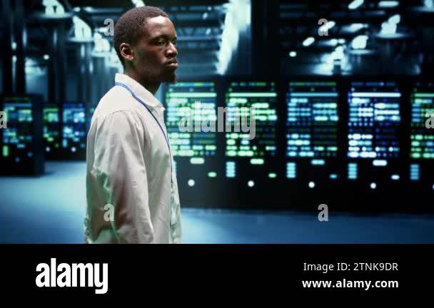 Electrician walking in high tech server facility performing data backups and providing ...