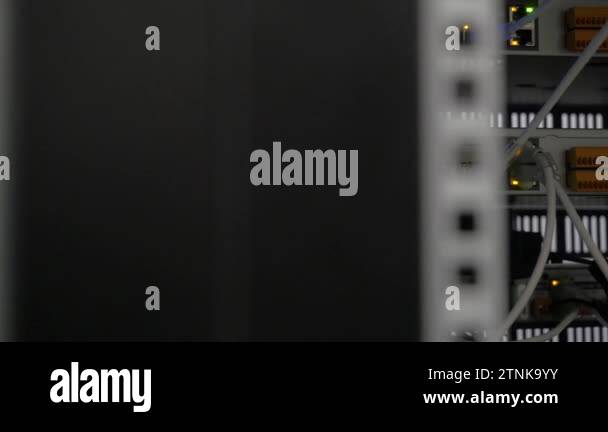 Back of the server installed in the server room. Many cables are ...