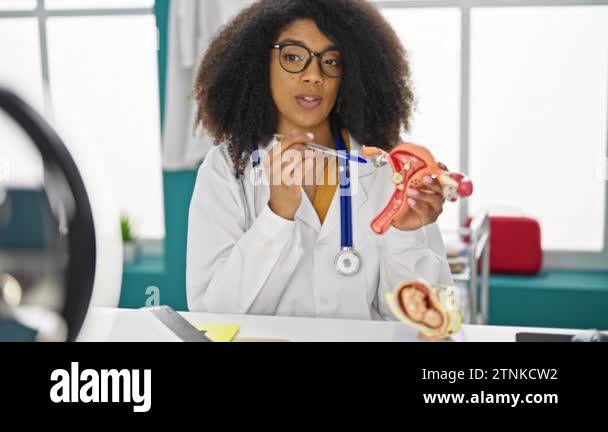 African american woman gynecologist doctor recording video tutorial of ...