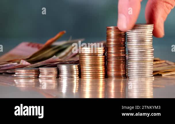 A hand takes away money and coins from a stack on a table Stock Video ...