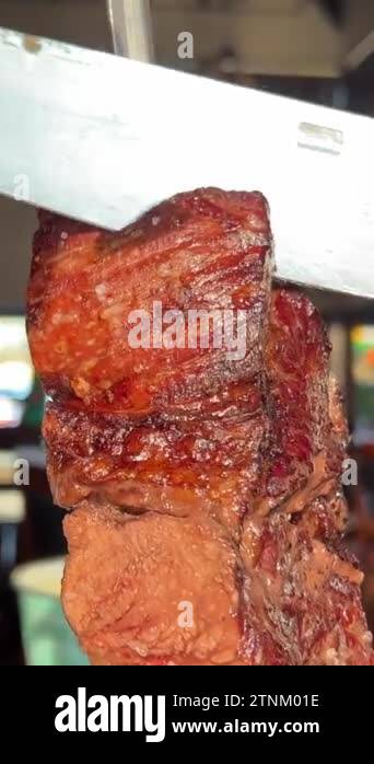 meat restaurant cut off barbecue meat large piece with a huge knife on ...