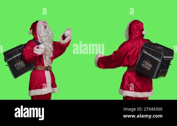 Man in santa suit with delivery backpack over greenscreen background ...
