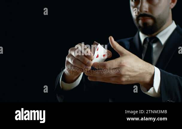 Close-up of a Professional Magician in a Black Suit Performing Card ...