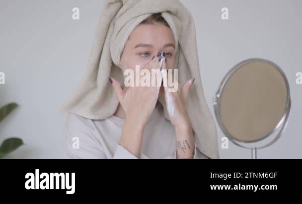 Woman is washing cleaning face with organic foamy soap cleanser. Girl ...