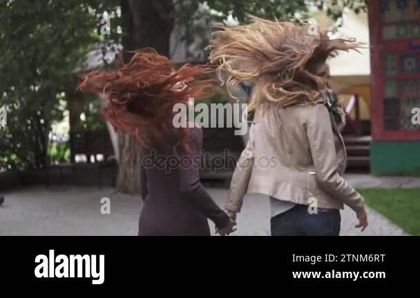 two crazy redheads girlfriends having fun, frolic and jump. the view ...