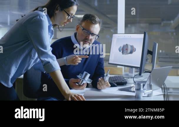 Female Industrial Technician and Male Chief Engineer Designing 3D Turbine/ Engine Model with ...