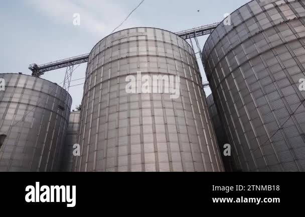 Modern grain elevator terminal in sea port. Metal tanks and conveyors ...