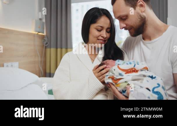 Maternity and Parenthood Concept. Happy parents in postnatal hospital ...