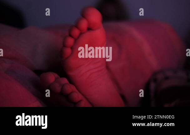 Two pairs of female feet in bed stroking each other. Foot fetish. LGBT ...