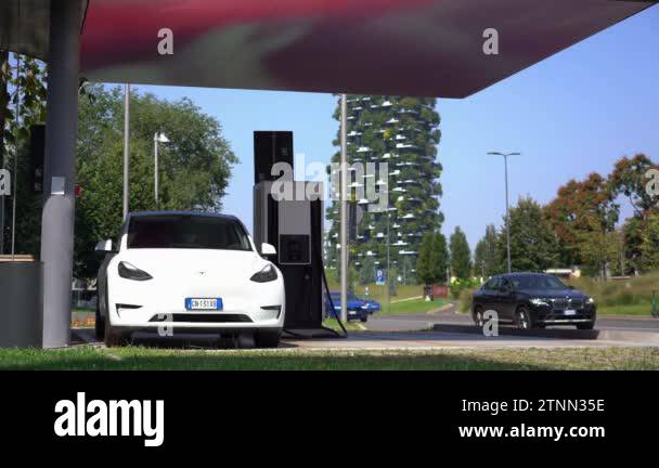 Europe, Italy, Milan 08-25-23 - Tesla electric car is charging the ...