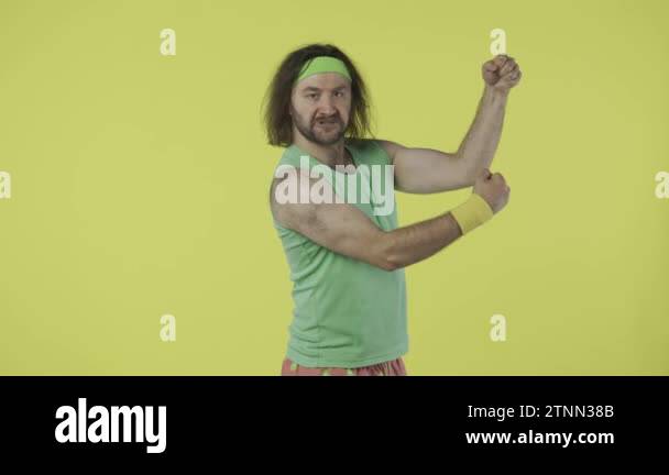 Man in sportswear standing, looking at the camera and showing his ...