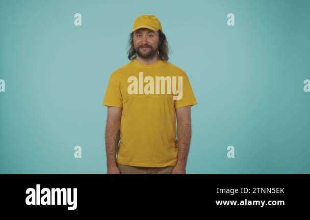 Courier service concept. Portrait of a delivery man in yellow cap ...