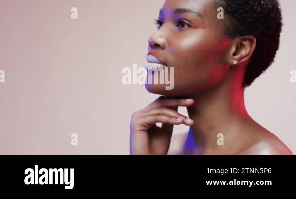 African american woman with short dark hair in blue and pink light with ...