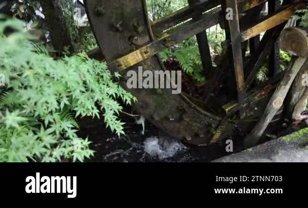 A historic wooden wheel on the water surface in Tokyo. High quality 4k ...