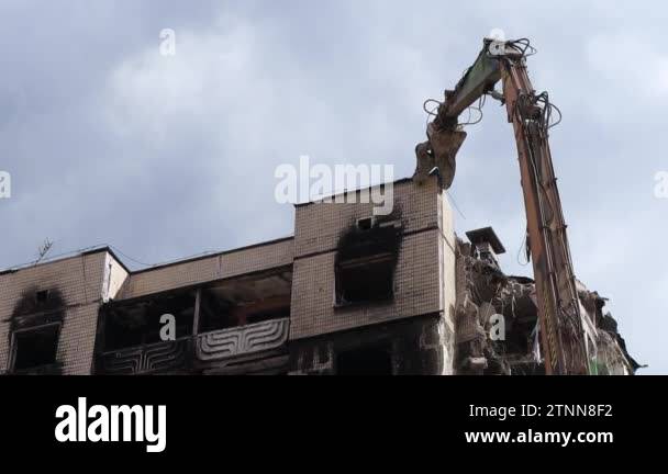 Excavator with hydraulic crusher at the demolition of a residential ...