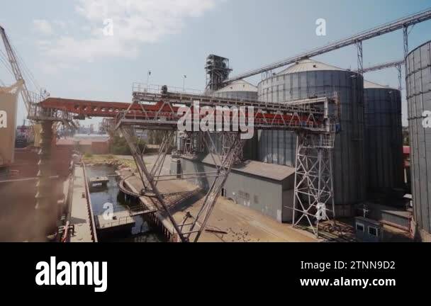 Grain loading to bulker ship cargo container at sea grain terminal in seaport. Wheat shipment ...