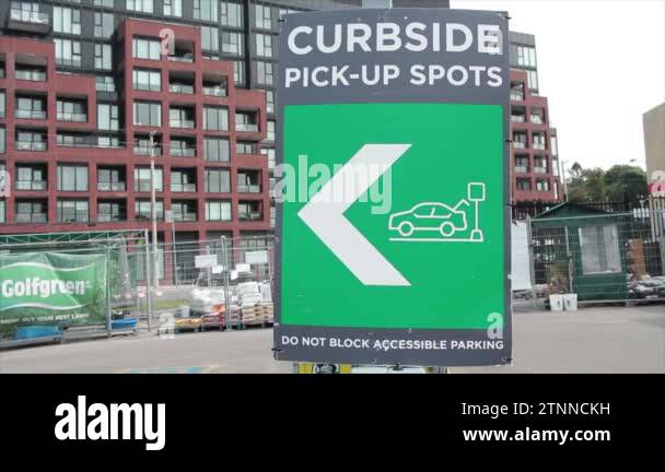 curbside pick up spots sign with arrow and illustration of person going ...