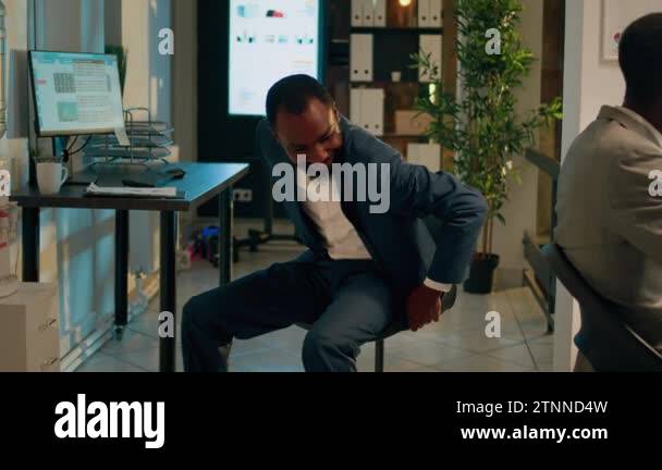 Colleagues laughing and having fun at work during nightshift, using ...