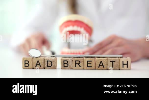 Dentist cleans teeth of an artificial model of human jaw and text bad ...