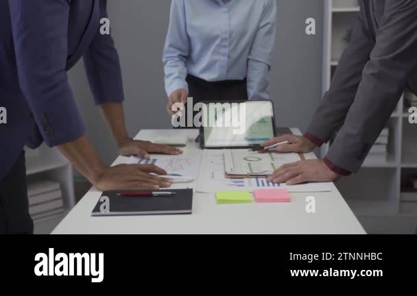 Successful asian business team handshake celebrating good job while shaking hands in meeting and ...