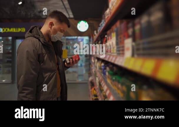 Man chooses groceries in store, walks with shopping basket, buys ...