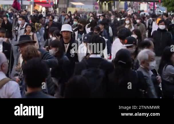 Tokyo, Japan-10 April, 2023: Large crowd of people walking through the Shibuya Crossing, show ...
