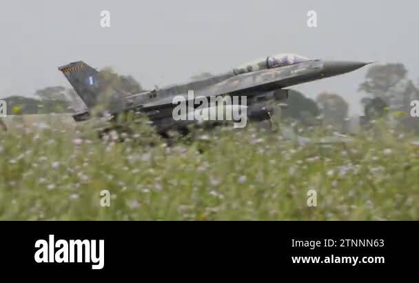 Hellenic Air Force two seat F-16 fighter jet landing in heavy rain. The ...