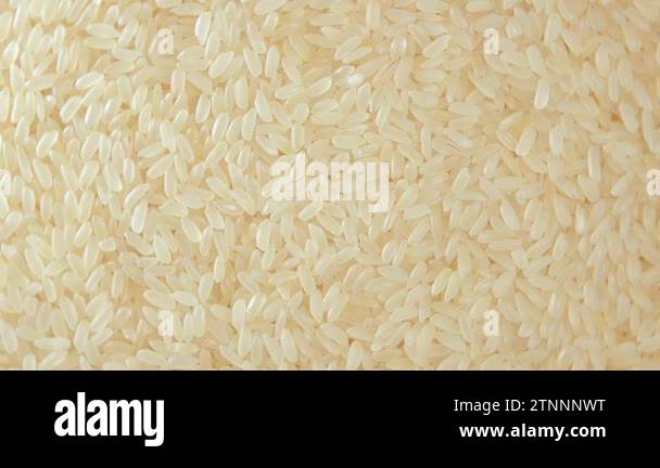 Dry Uncooked Parboiled Rice Background Slowly Rotating Left - Top View ...