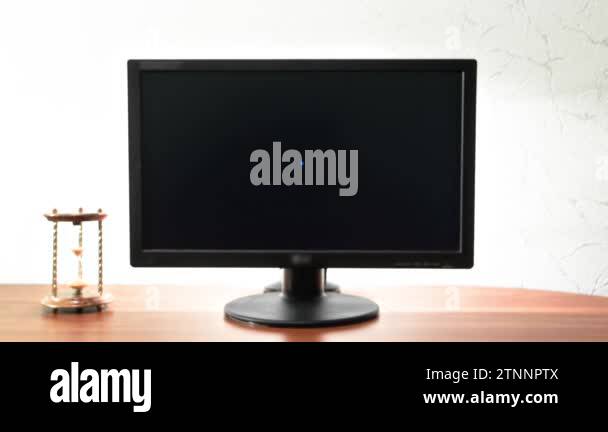 Work desk for digital job with computer, hourglass near the monitor ...