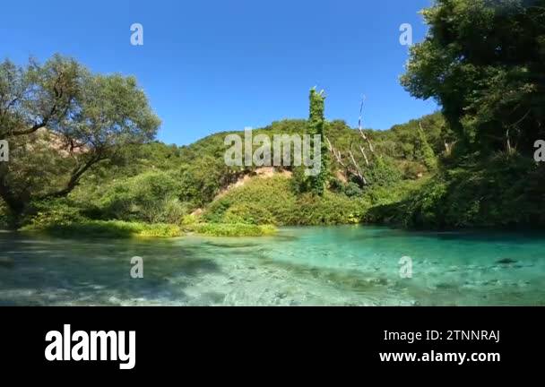 A tourist bathing in the cold waters of the river of The Blue Eye or ...