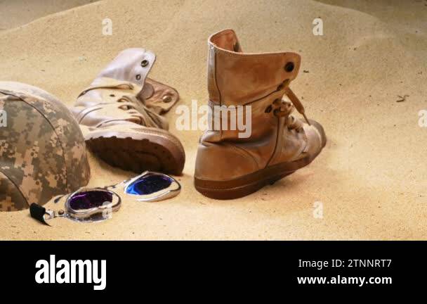 Parts of a soldier's uniform lay in the sand. Ruins after the war ...