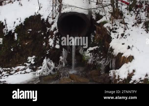 Concrete run-off pipe discharging water. Drain pipe, drainage. Runoff ...