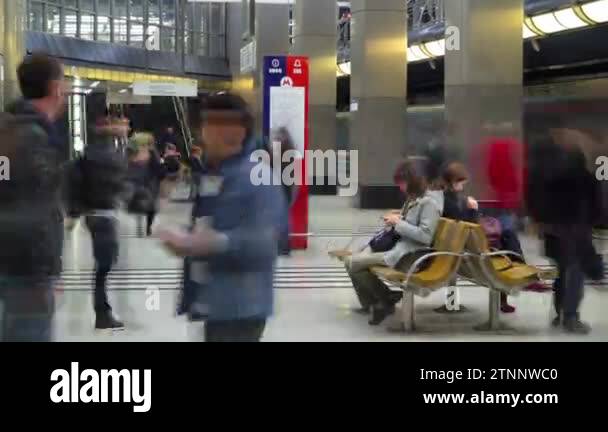 Interior of a modern subway station with trains timelapse. People ...