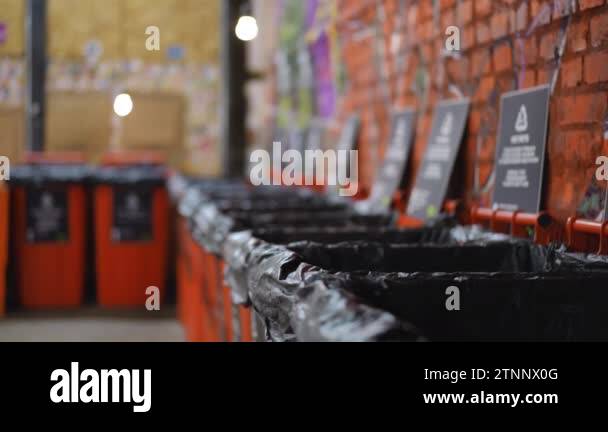 Rows of garbage bins for different types of trash at recycle station ...