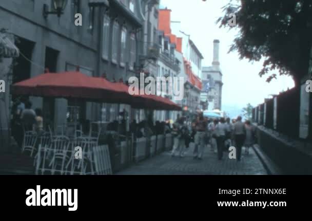People walking on cobbled street in Quebec City central area in 1970s ...