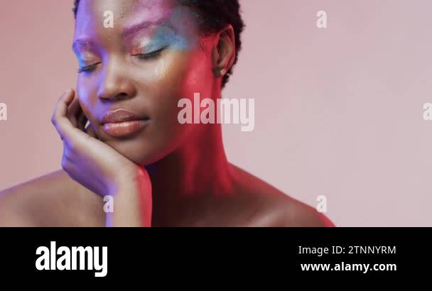 African american woman with short dark hair in blue and pink light with ...