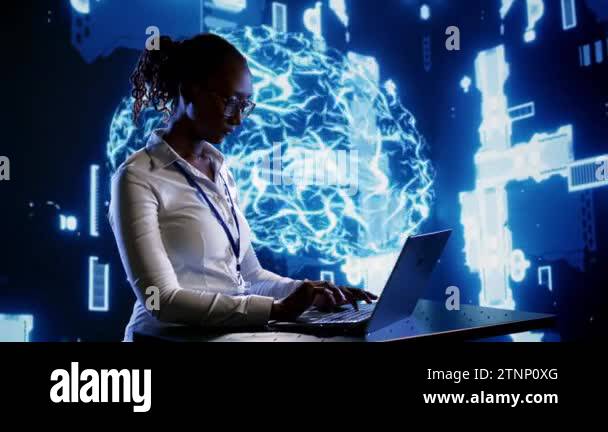 Certified expert using laptop to maintenance artificial intelligence neural networks made up of ...