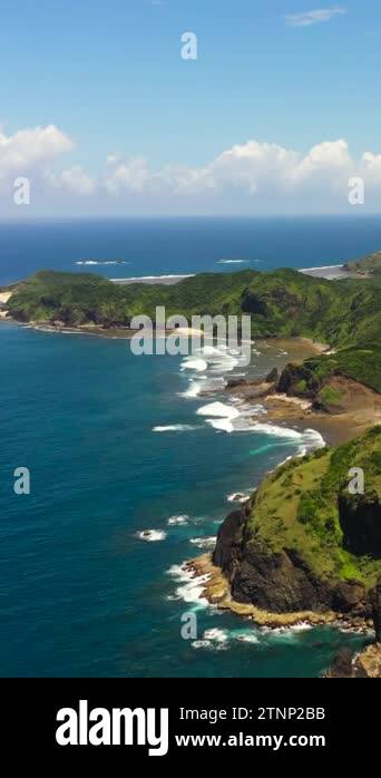 The coast of the island with beaches and rainforest. Cape Engano ...