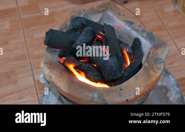 Burning charcoal in stove for preparing traditional food of Thailand ...