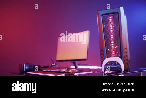 Video of computer and gaming equipment on desk with copy space on neon ...