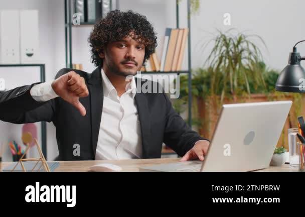 Dislike. Upset indian businessman guy working on laptop computer at ...