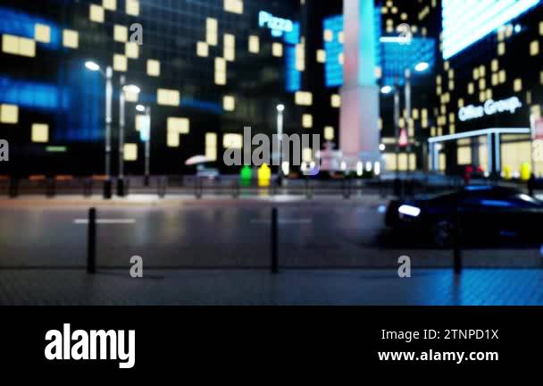 Ground level panning shot of urban city boulevard at night with cars ...