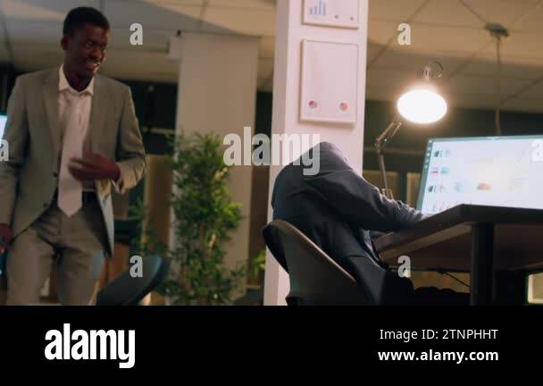 African american hyperactive employee sneaking up on tired coworker ...