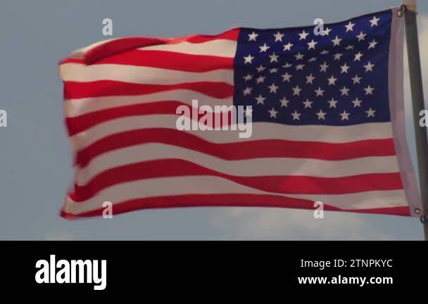 American Flag Waving Slow Motion. Large American Flag flies. US flag ...
