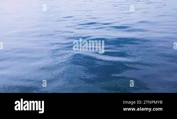 Waving water on a lake in shades of blue and white. An opaque wave of ...