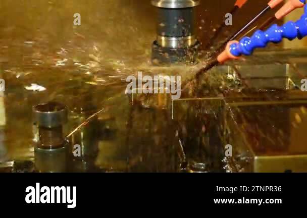 The CNC milling machine cutting the tire mold parts with oil coolant ...