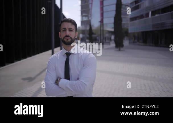 Attractive young confident business man posing outside office building ...