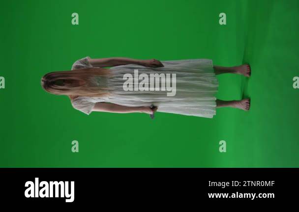 Full-size vertical green screen, chroma key video of a posessed female ...