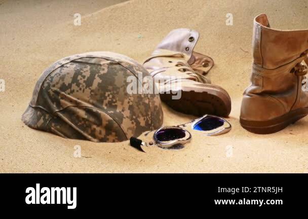 Parts of a soldier's uniform lay in the sand. Ruins after the war ...