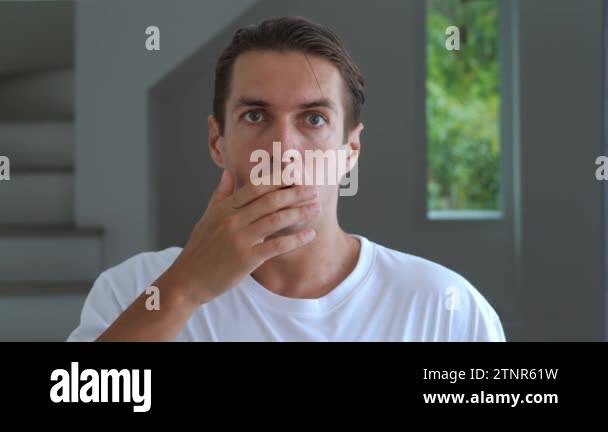 Fright concept. Close-up scared man covering mouth in fright reacting ...
